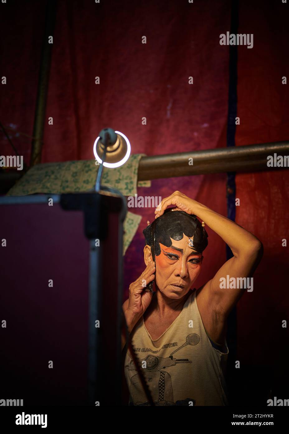 Getting ready for the opera show. A Chinese opera performer put her ...