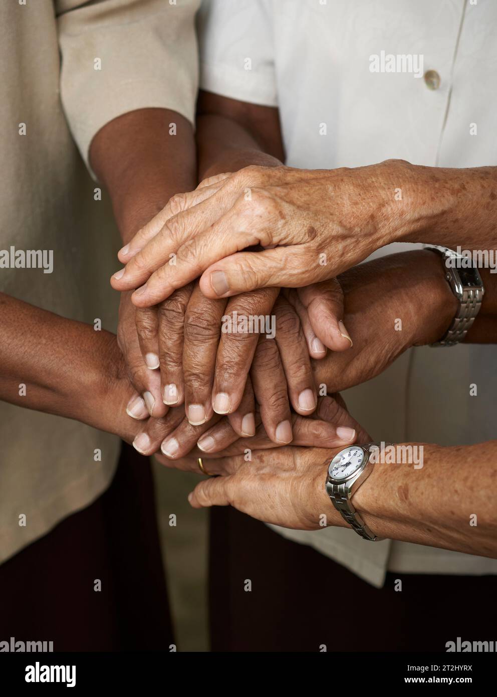 Close up of elderly people putting their hands together. Friends with ...