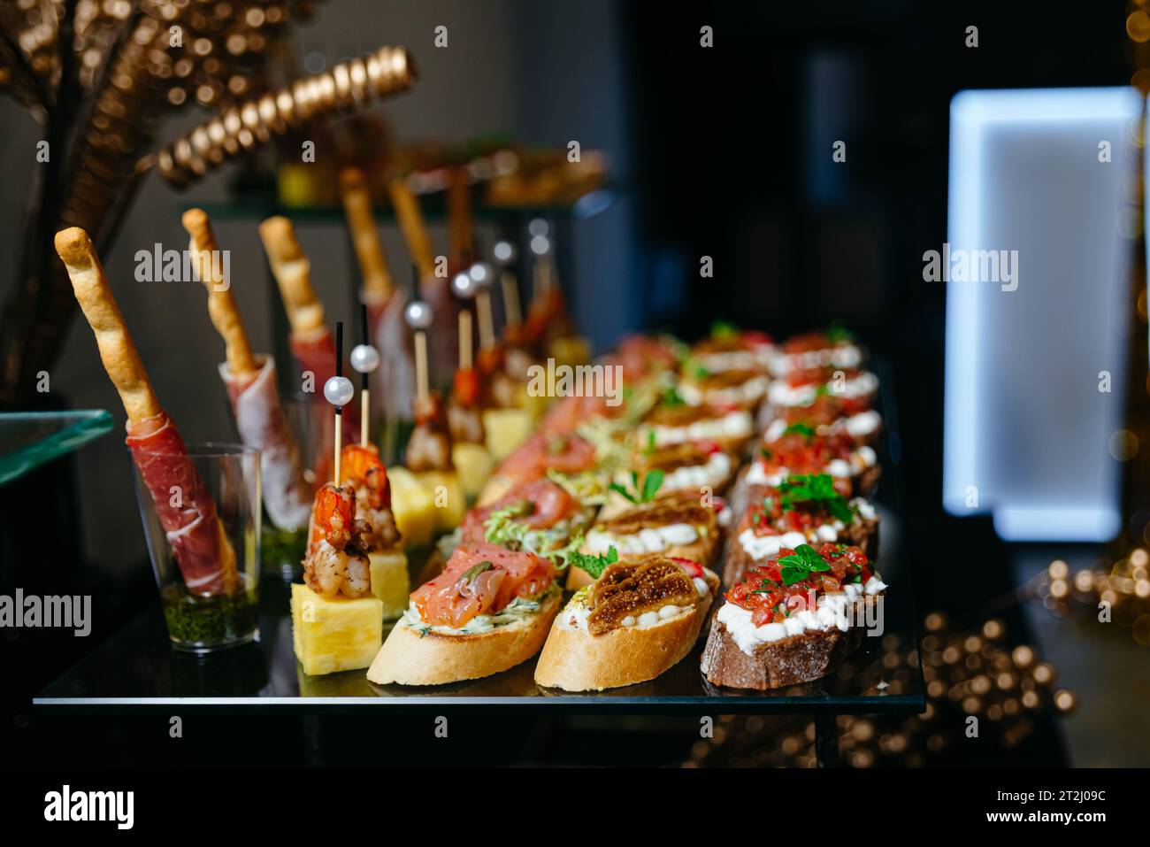 Canape on glass table. Canape various cheeses, tartare, salmon, salsa ...