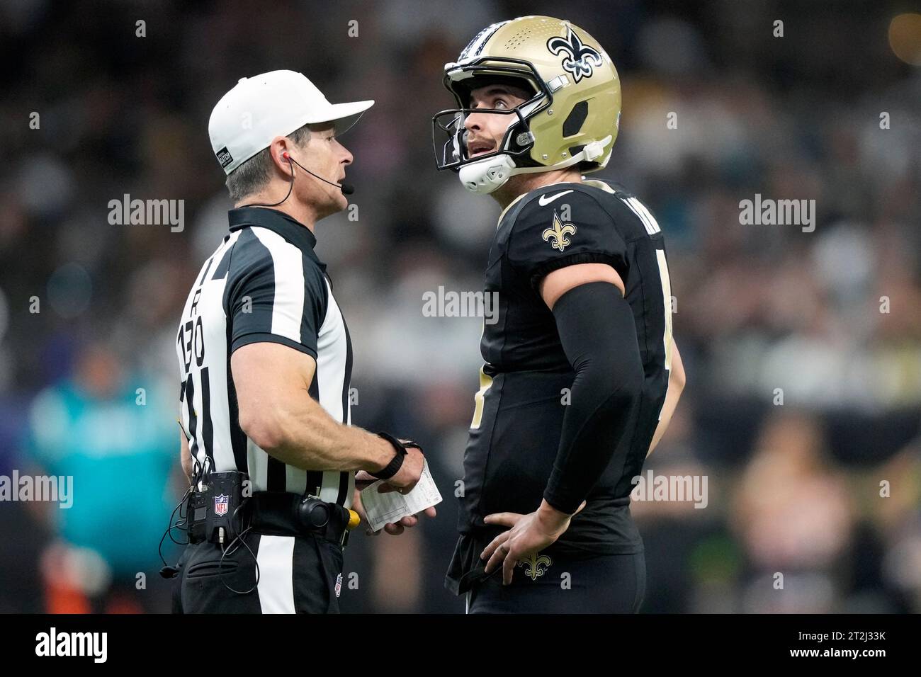 Referee Land Clark (130) talks with New Orleans Saints quarterback ...