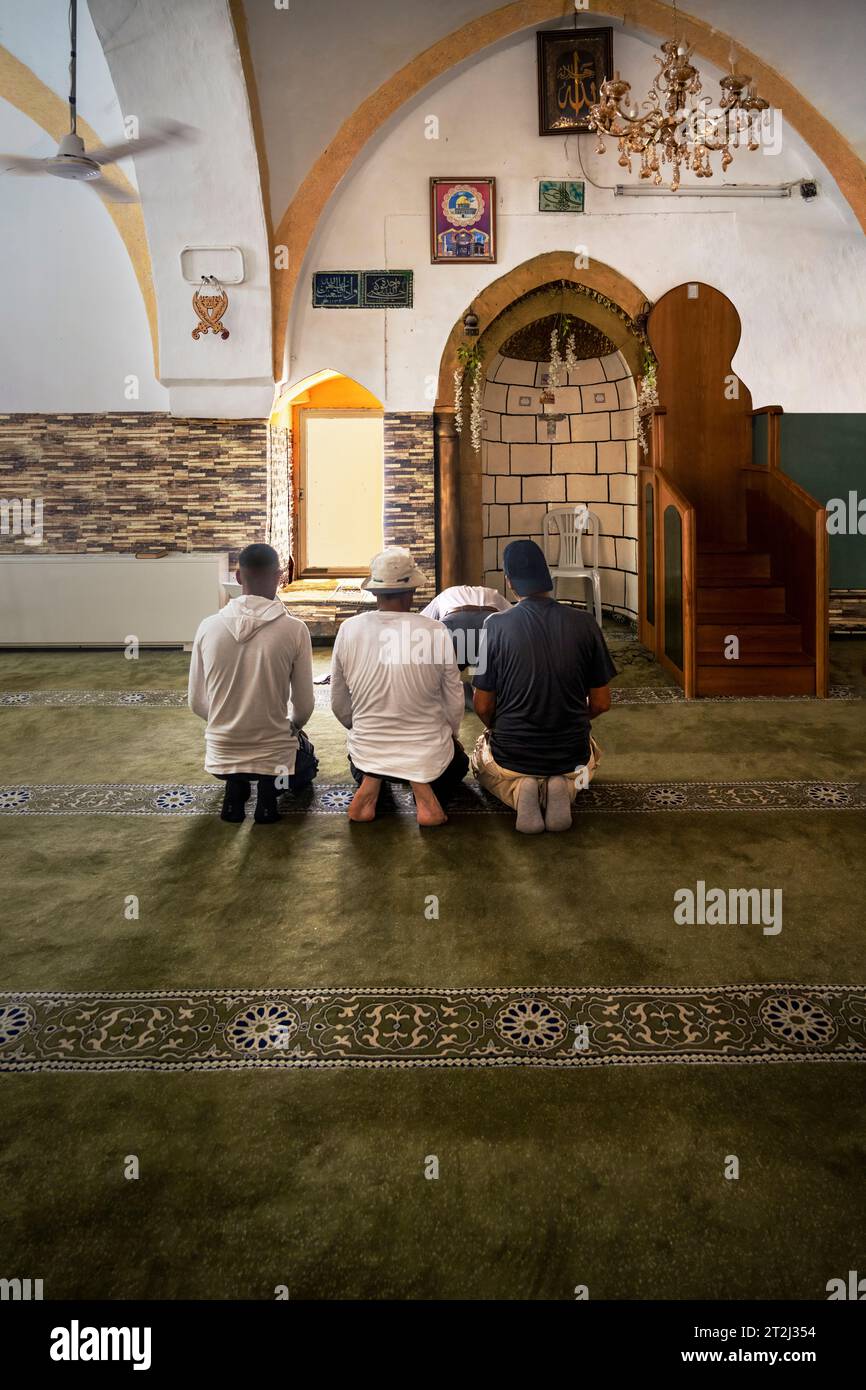 Jerusalem, Israel, August 12, 2023: Men praying in the Muslim shrine ...