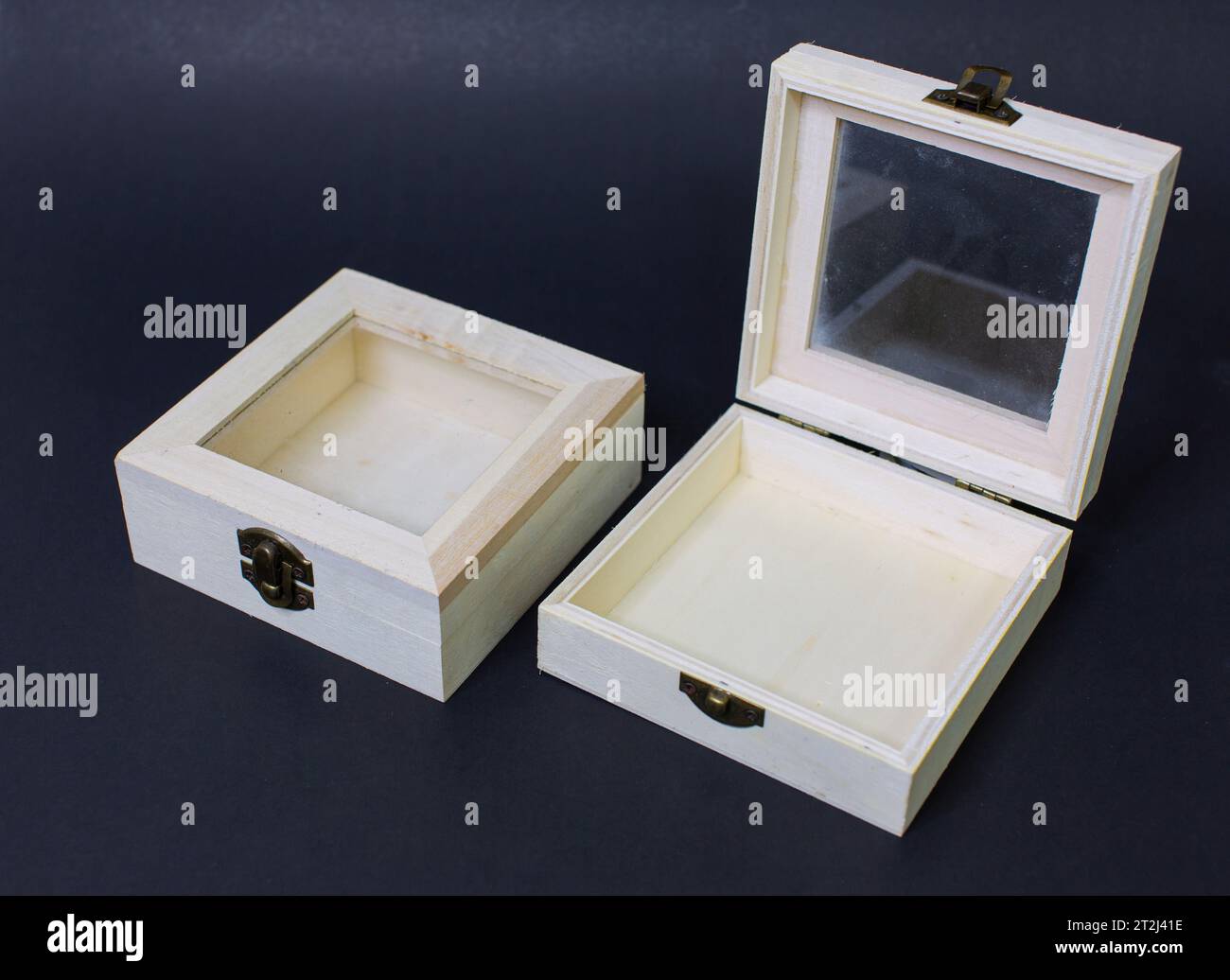 2 small empty light brown wooden boxes Container objects are locked ...