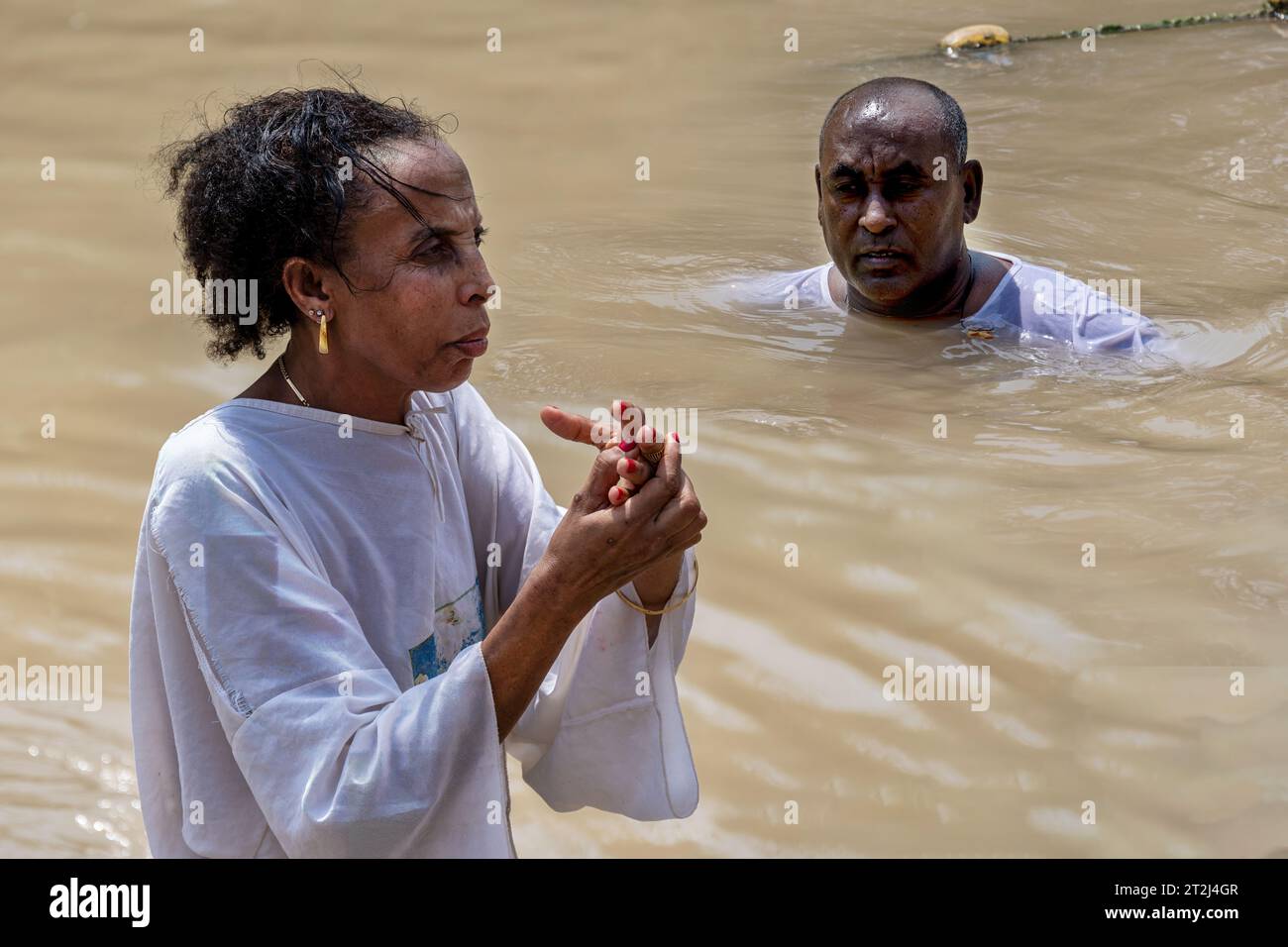 Galilee, Israel - August 13, 2023. Pilgrims bathing in the river Jordan ...