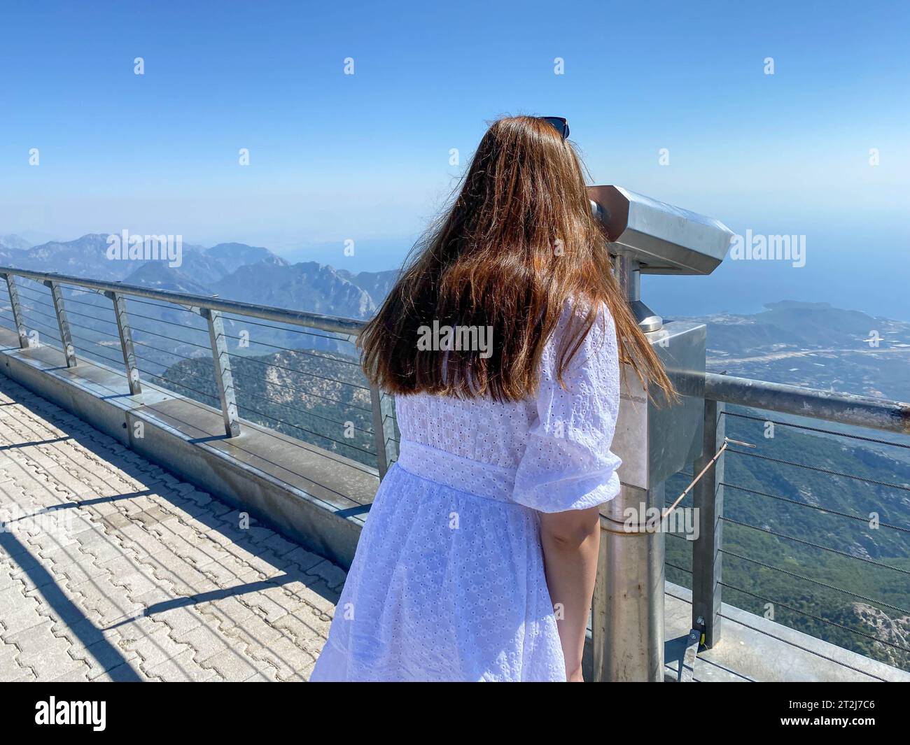 Female hands hold sightseeing touristic telescope. View from the ...