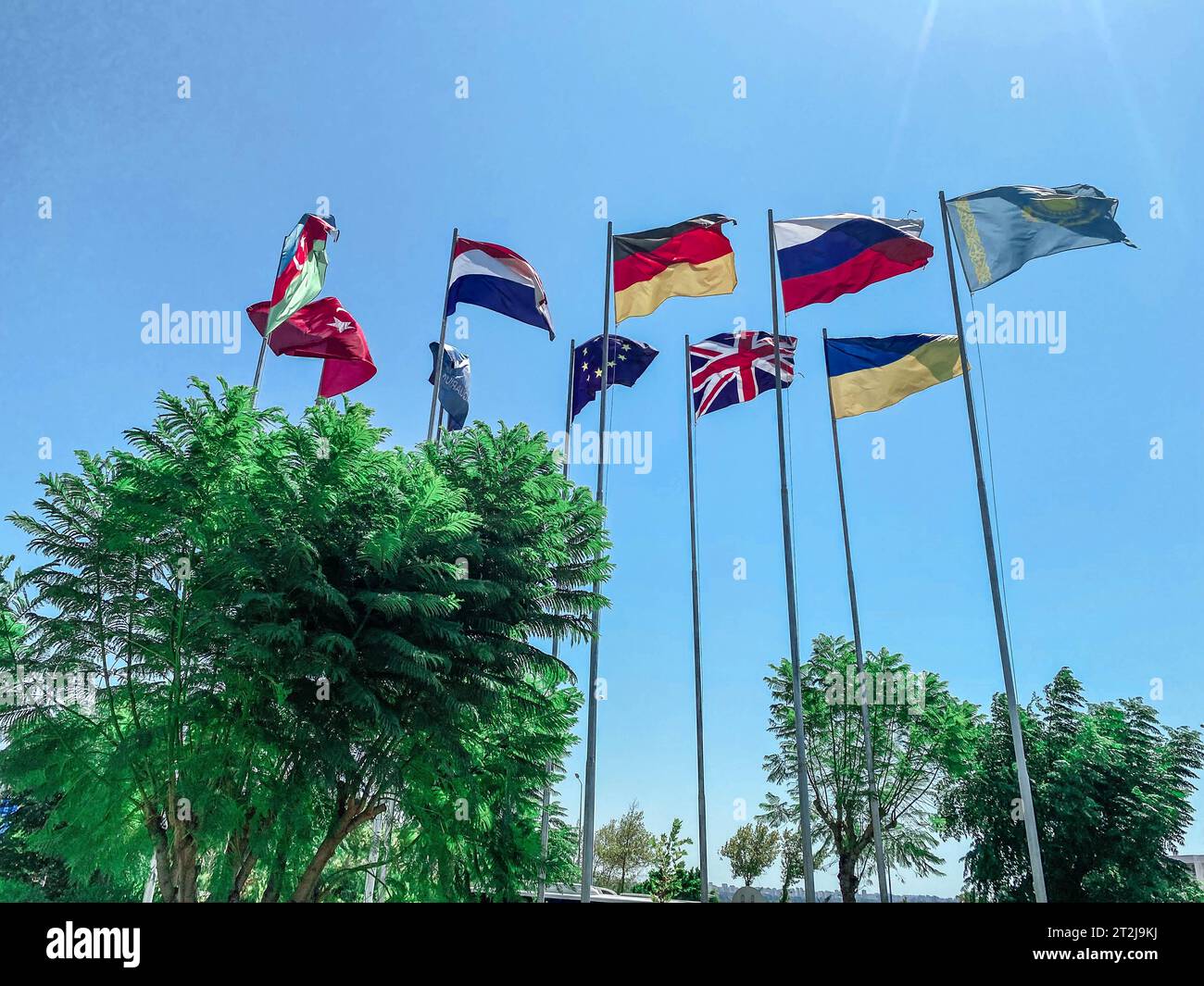 central square in the city. on it are flagpoles with flags of different ...