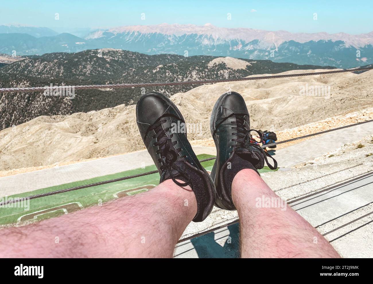 male legs in black, leather sneakers. shoes made from natural ...
