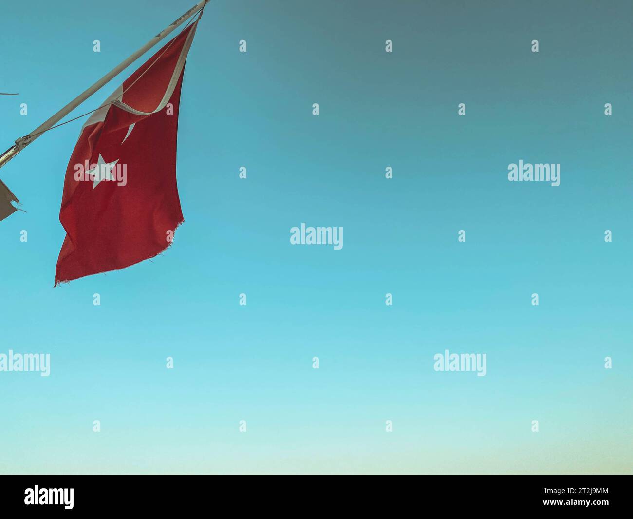 Turkish flag against the blue sky. red flag made of fabric with a ...