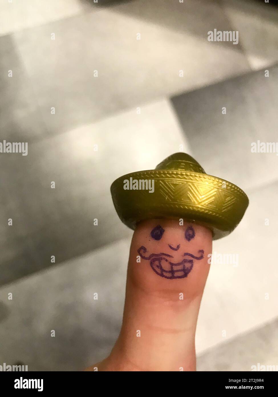 Thumb, finger Mexican in gold hat sombrero with painted cheerful ...