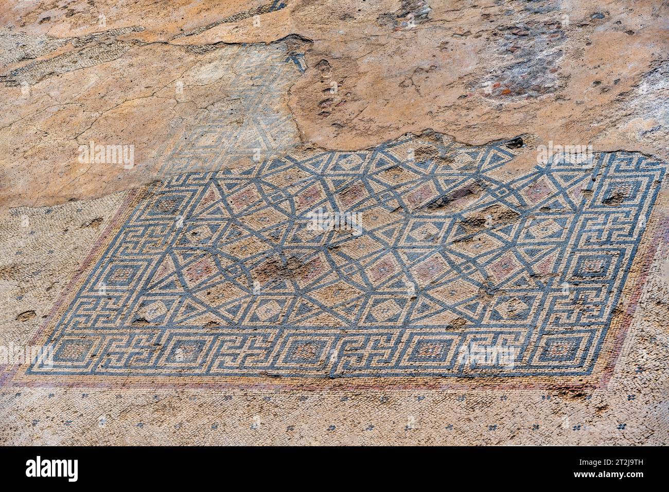 Ancient, antique mosaic of small colored tiles with geometric pattern ...