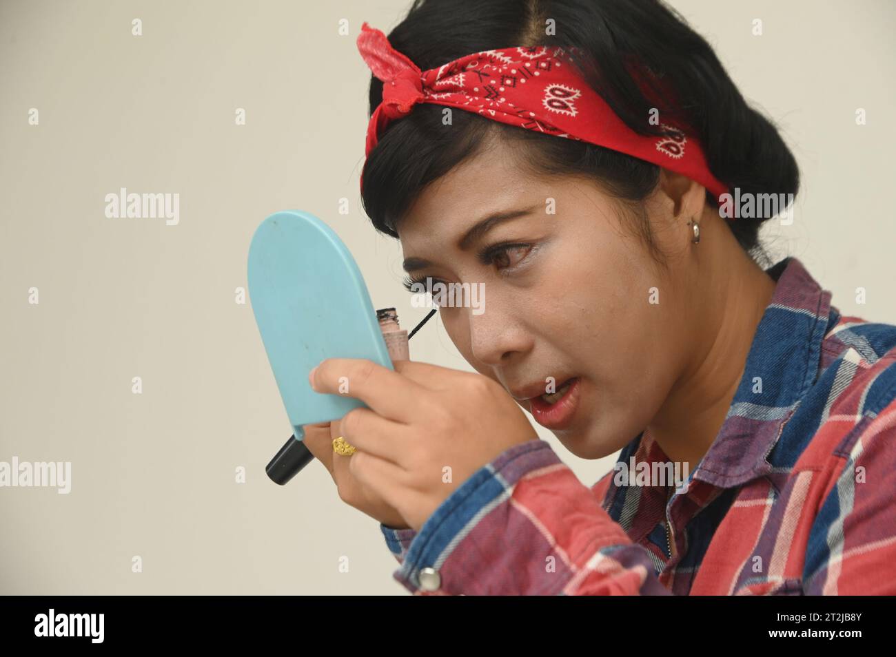 Beautiful Asian woman with dark eyebrows hold eyebrow brush. Eyebrows ...