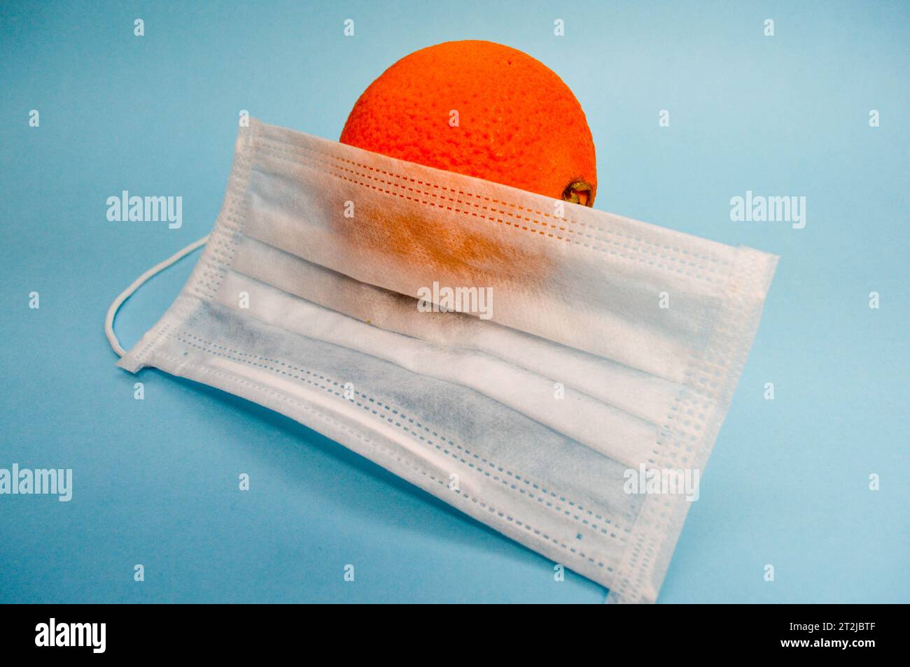 Citrus orange with vitamin C and a medical disposable protective mask ...