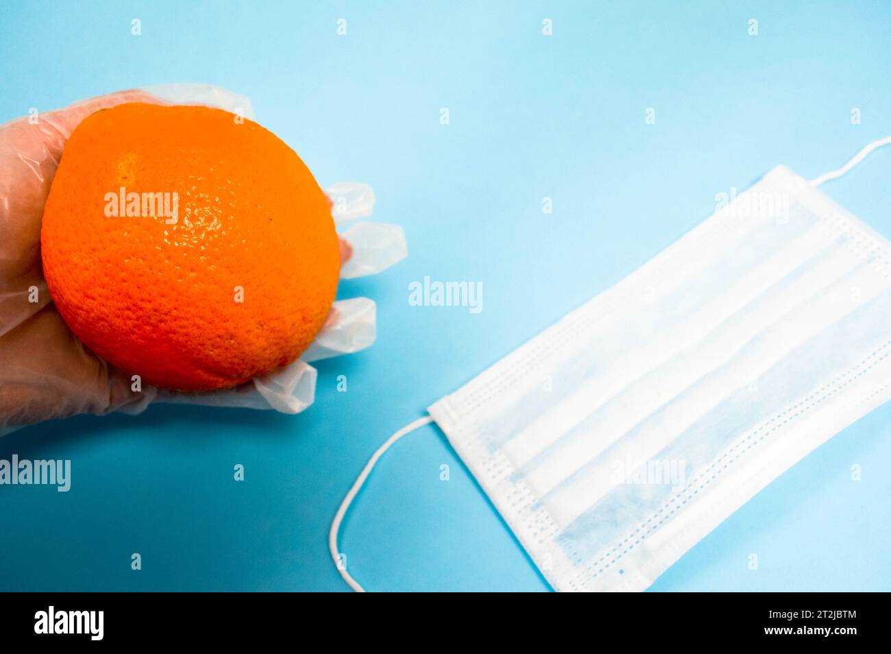 Citrus orange with vitamin C and a medical disposable protective mask ...