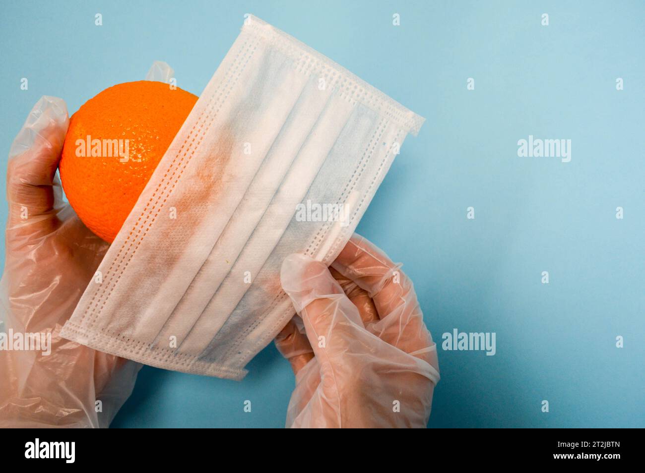 Citrus orange with vitamin C and a medical disposable protective mask ...