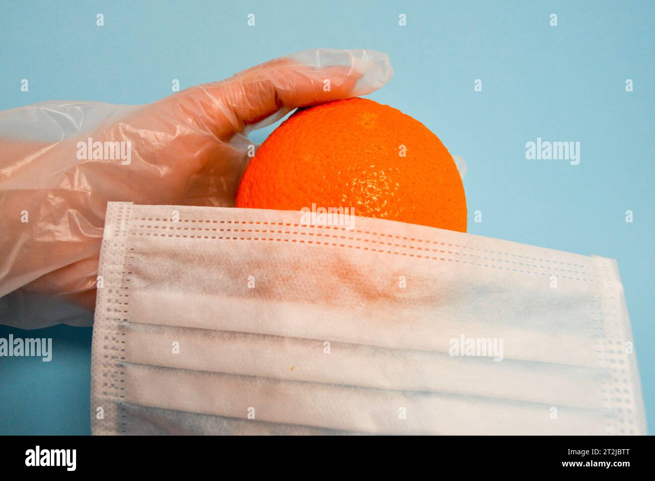Citrus orange with vitamin C and a medical disposable protective mask ...