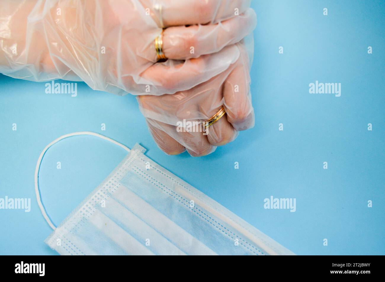 Gold wedding rings on hands in protective medical rubber disposable ...
