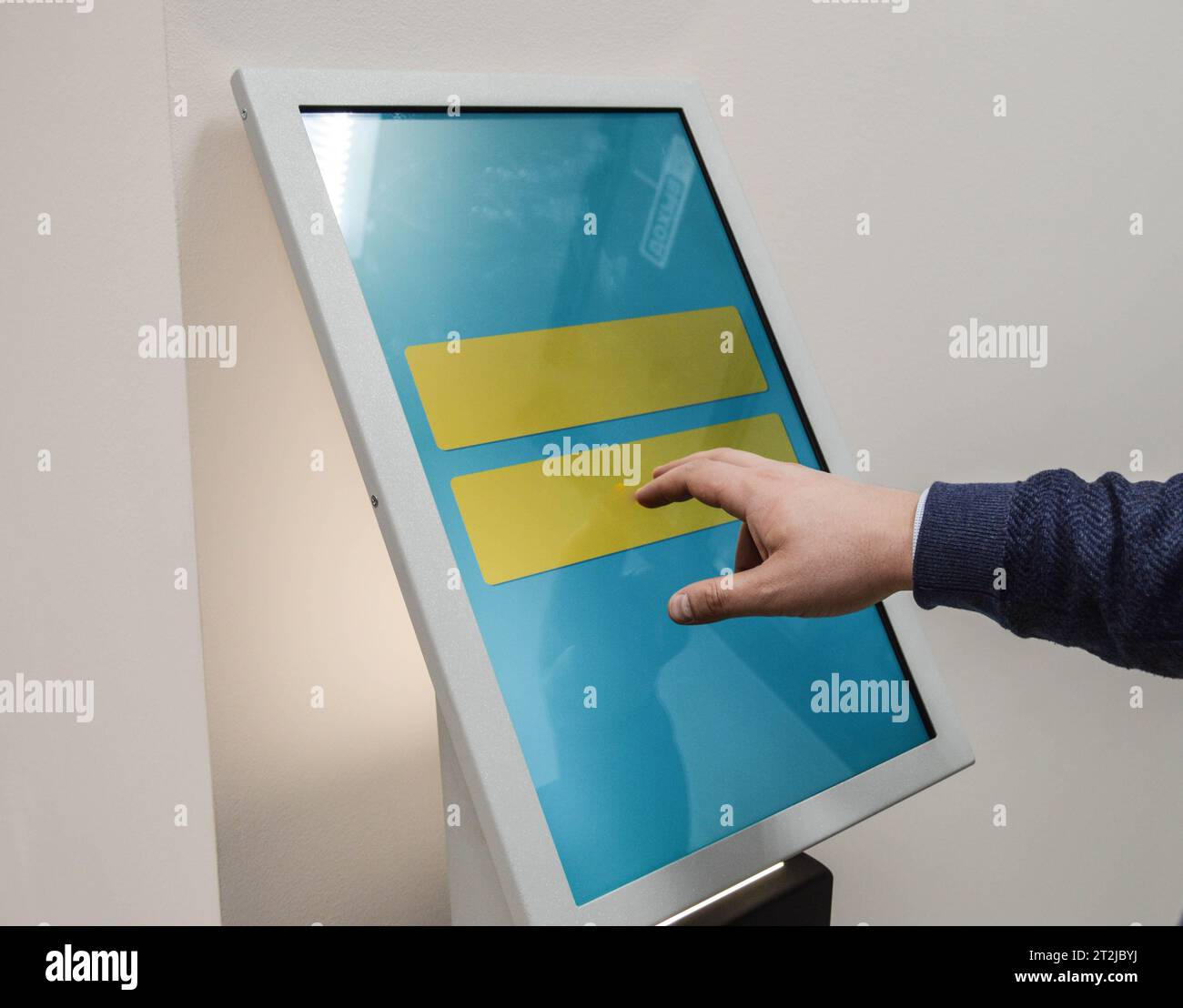 A man orders food in the touch screen terminal with electronic menu in ...
