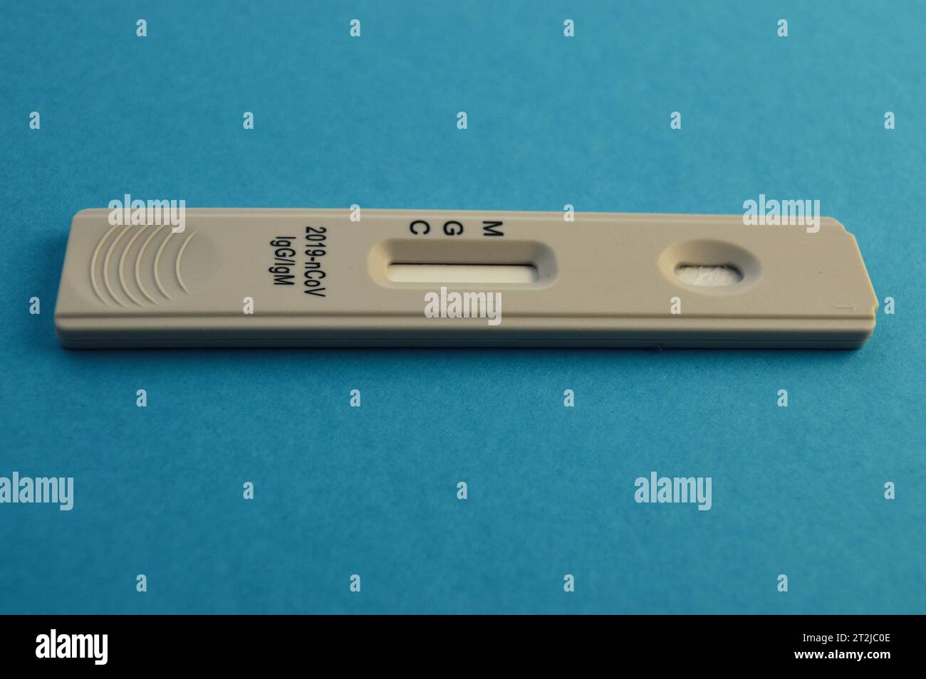 individual set for self-diagnosis of coronavirus. test strip on a blue ...