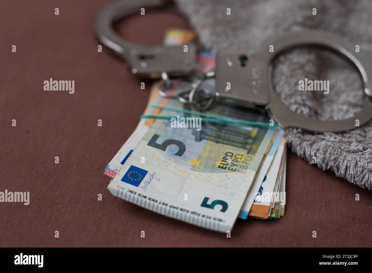Handcuffs - photo on money banknotes. Metal handcuffs are laying on ...