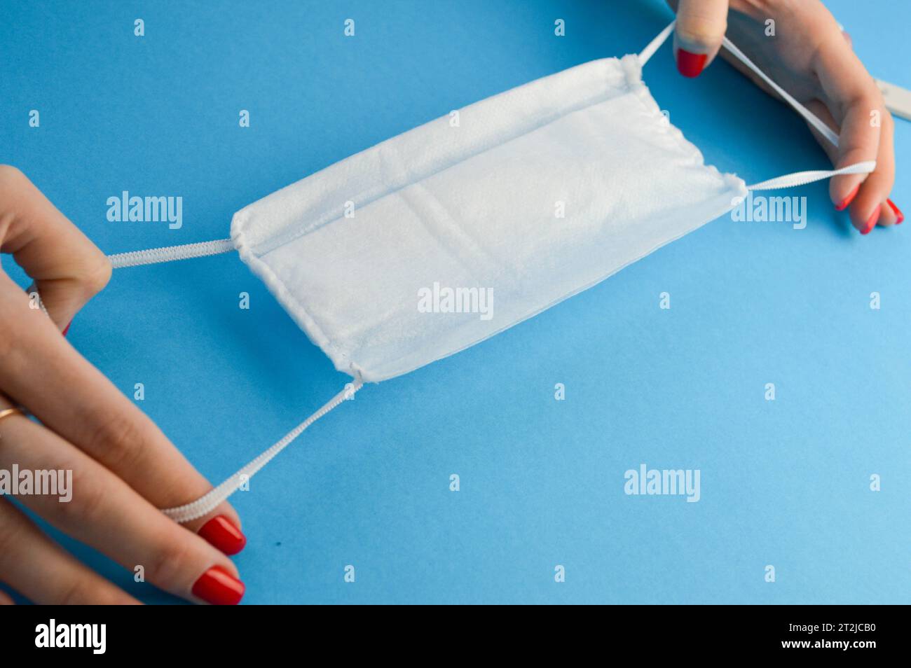 white mask on a blue background. sterile, disposable mask to protect ...