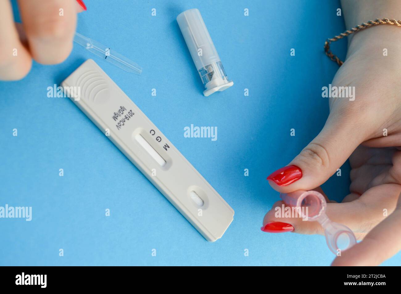 a pink plastic container for blood collection. a girl with a red ...