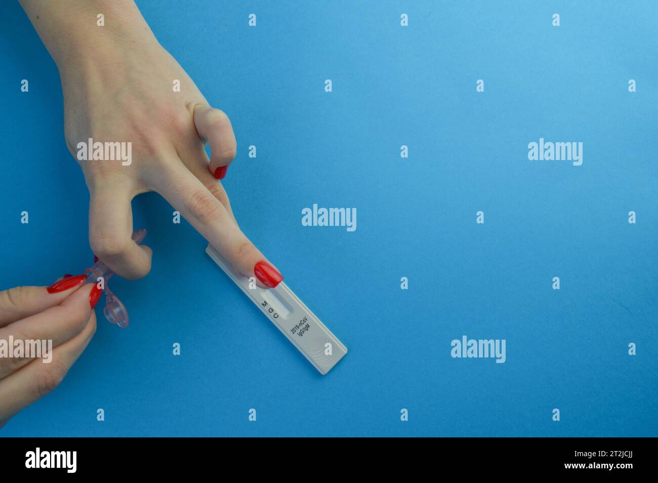 blood test for the diagnosis of coronavirus. a girl with a bright red ...