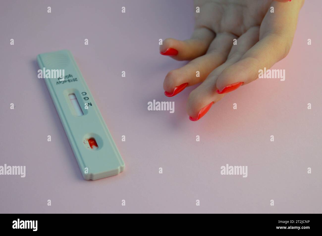 girl with a manicure makes a test for coronavirus. there is a bright ...