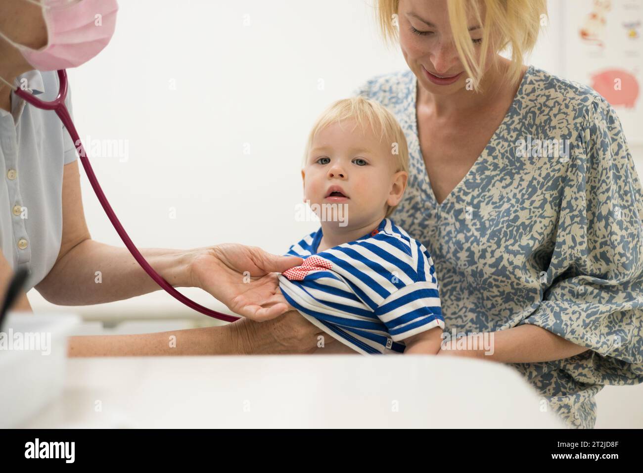Infant baby boy child being examined by his pediatrician doctor during ...