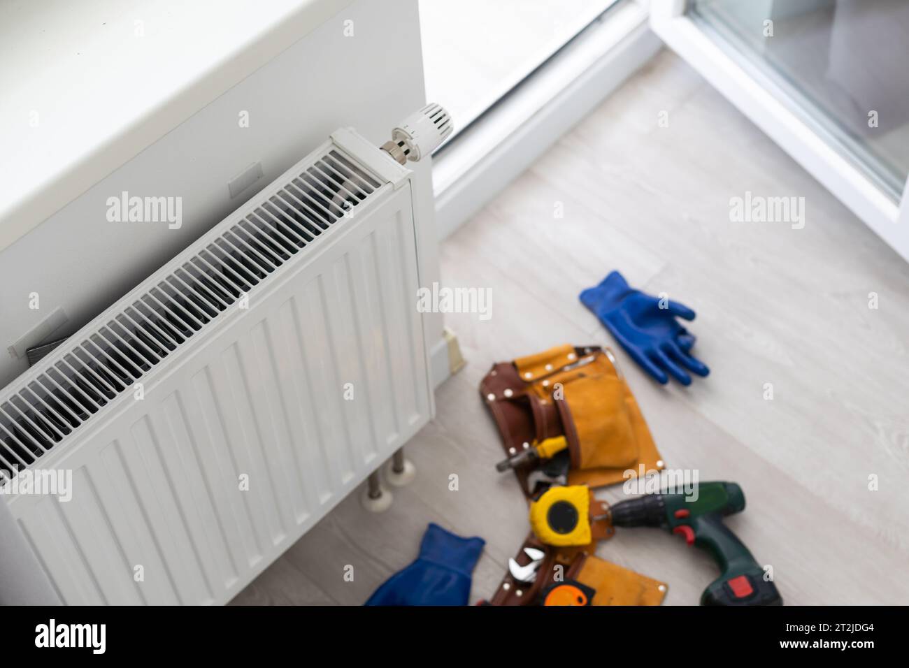 White hot water heater radiator built inside drywall indoors at home ...