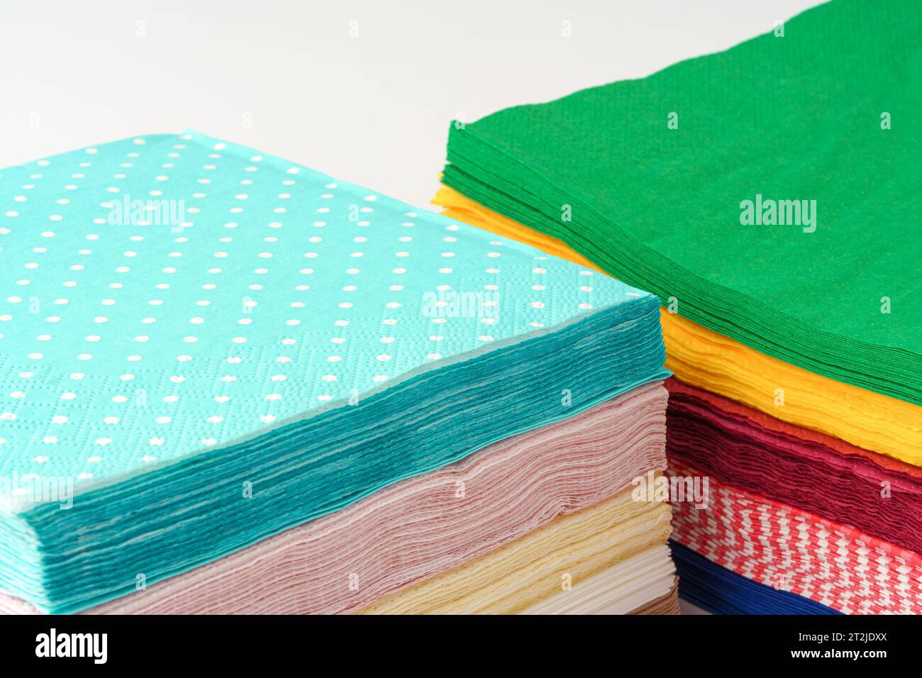 Two stacks of colorful paper napkins on white background Stock Photo ...