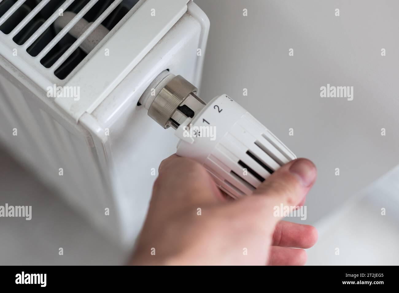 Heat radiator knob. Woman hand adjusting temperature on heating ...