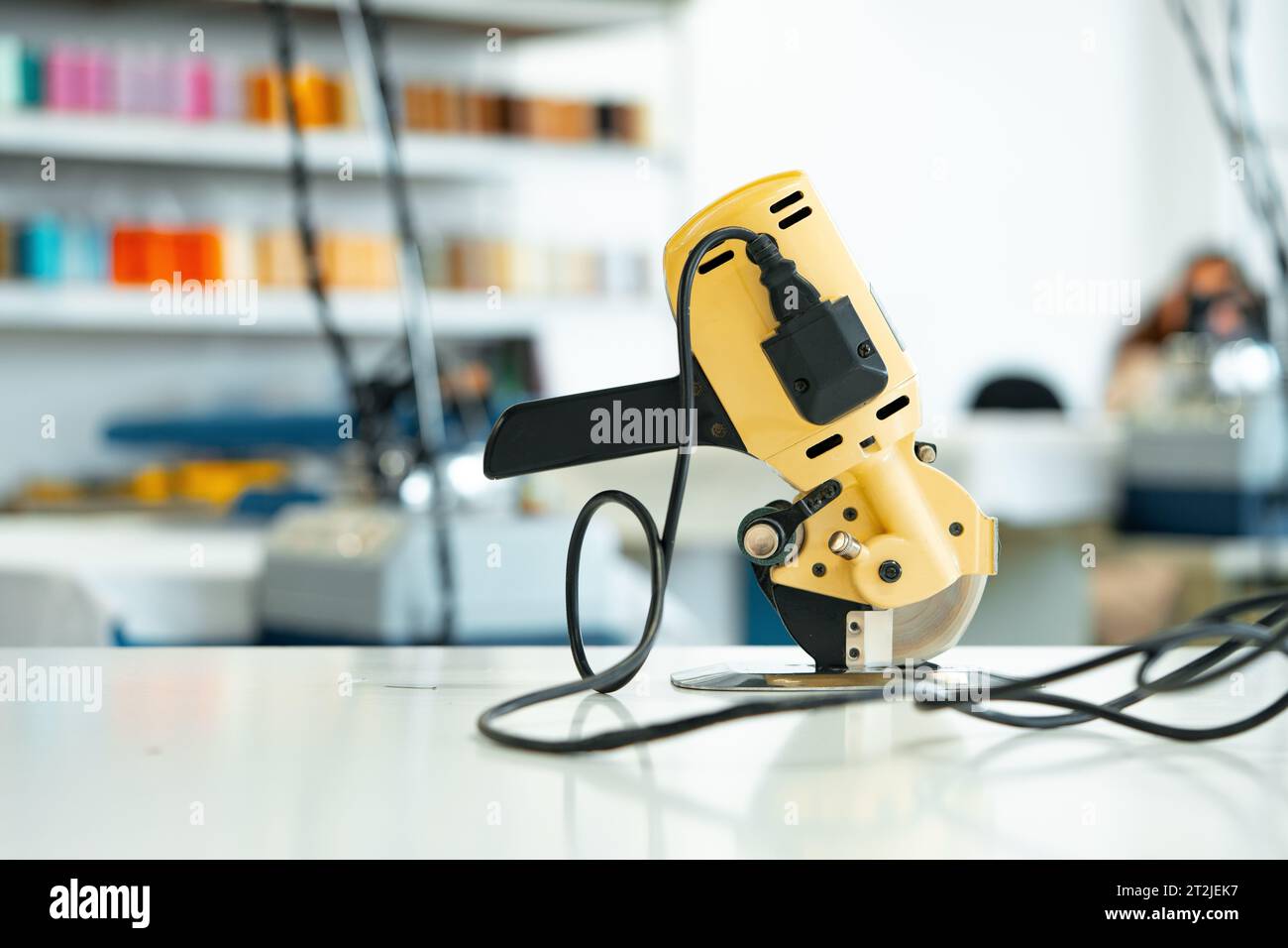 Electric cutting fabric machine on workbench in sewing factory Stock ...