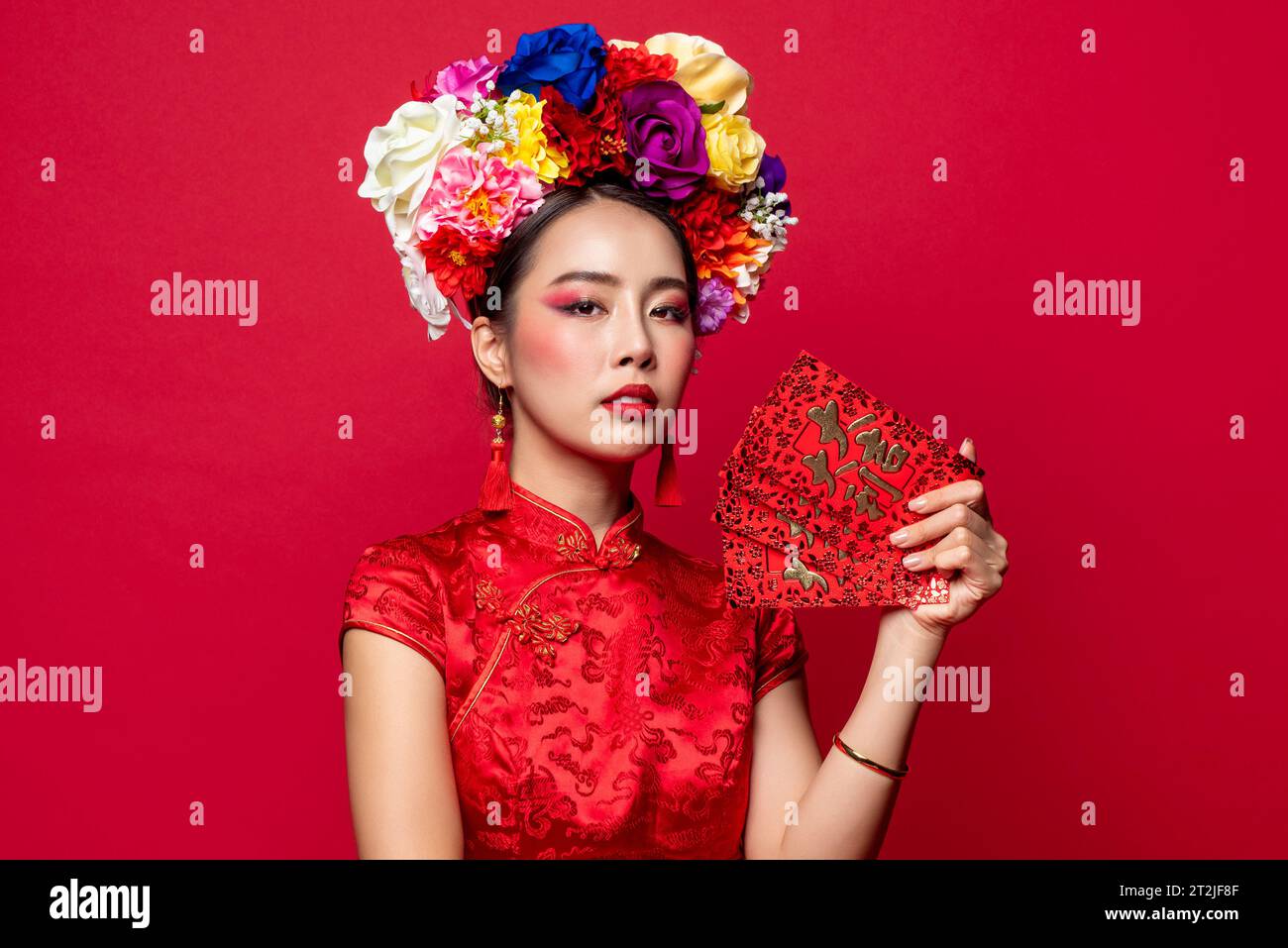 Elegant Asian woman in traditional oriental costume holding red ...