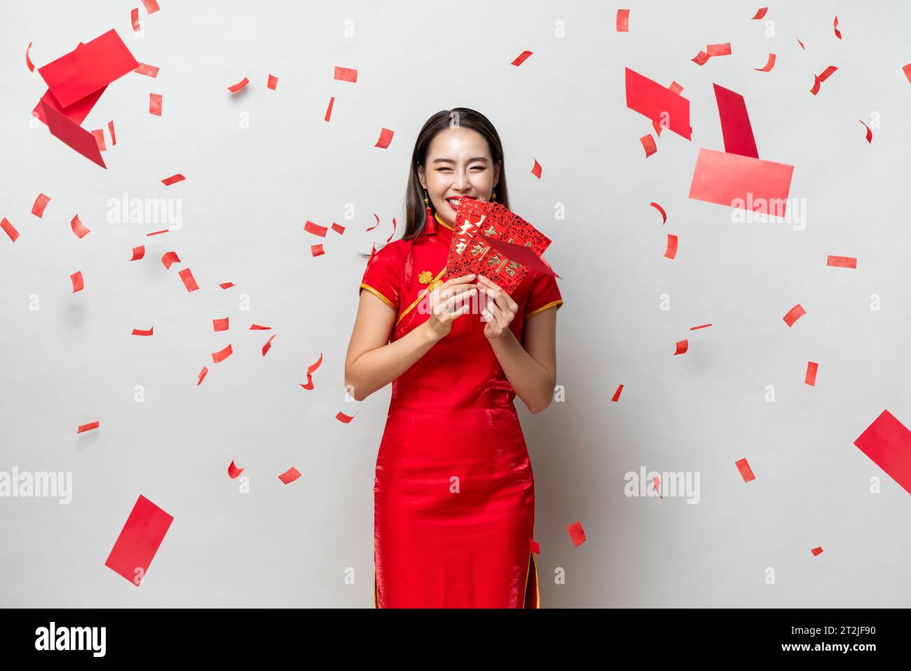 Smiling happy Asian woman in traditional oriental costume holding red ...