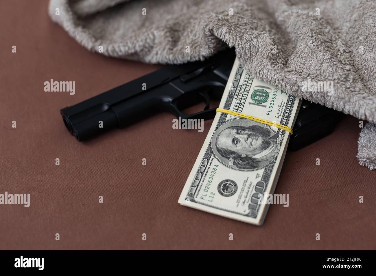 Handgun on the US dollars stack - - criminal money concept Stock Photo ...