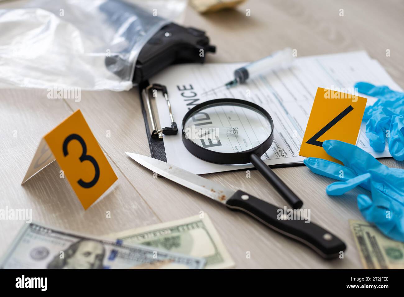 High contrast image of a crime scene with gun and markers on the floor ...