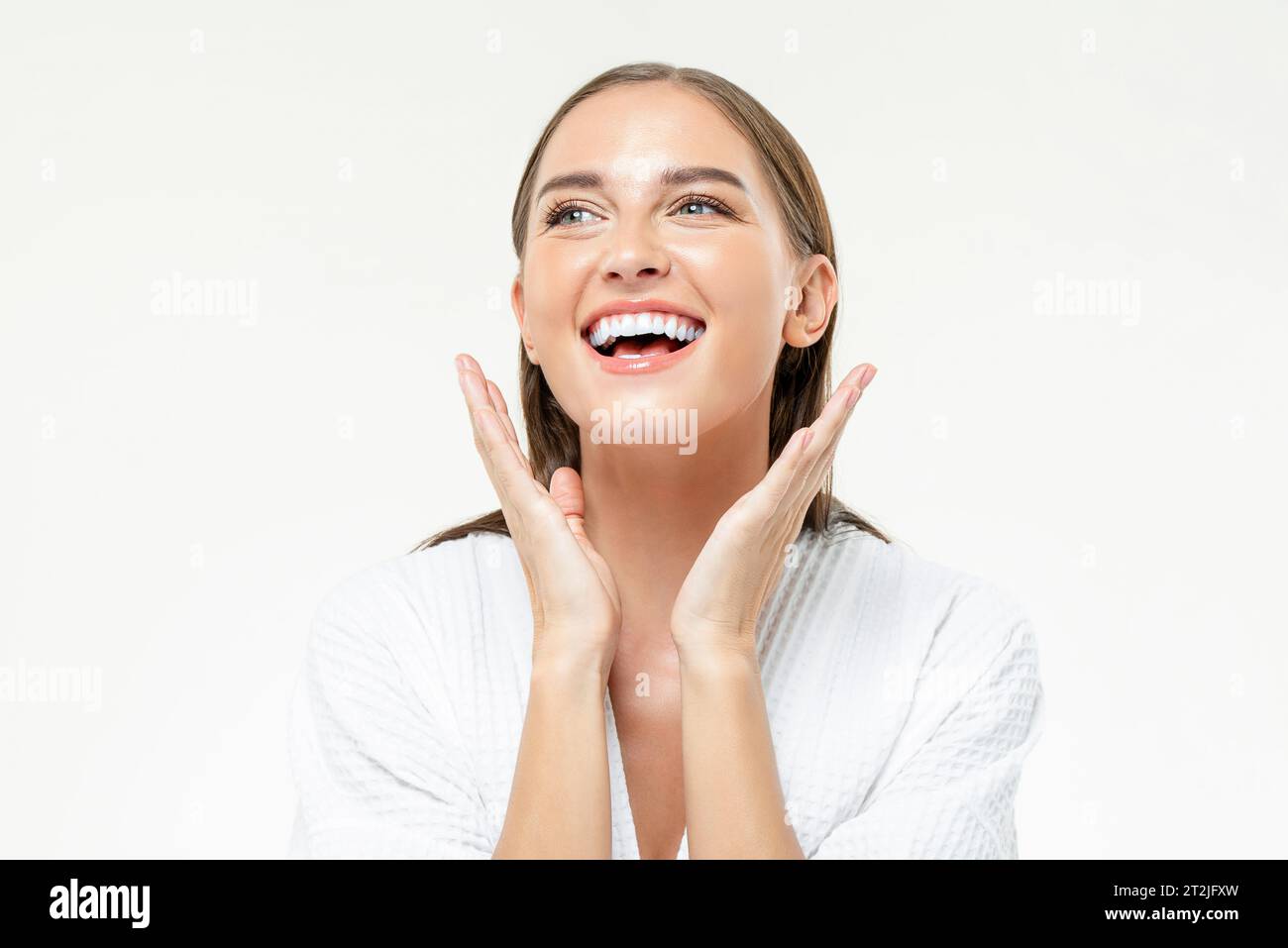 Optimistic female with clean face skin looking away with smile on white ...