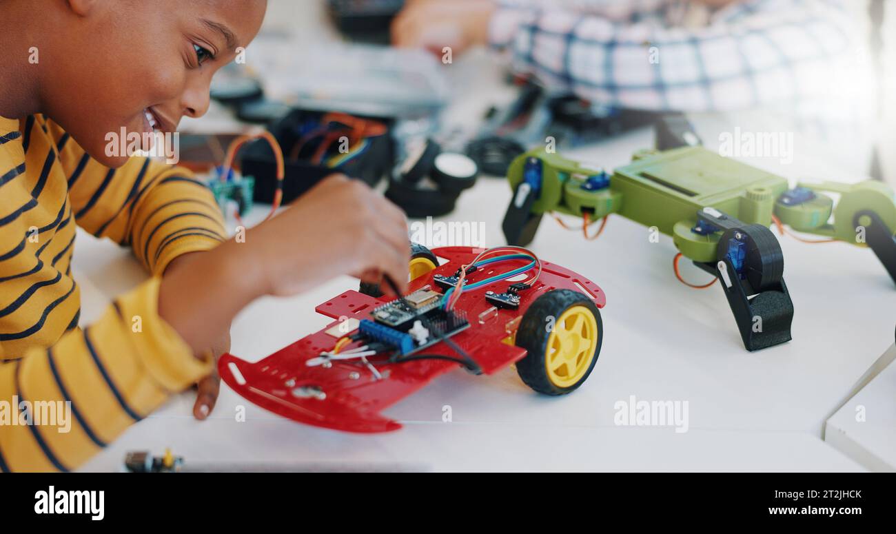 Robotics, boy and technology in classroom for education or learning ...