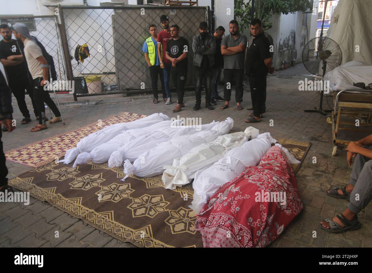 Palestinians stand around the bodies of the Awaja family killed in the ...