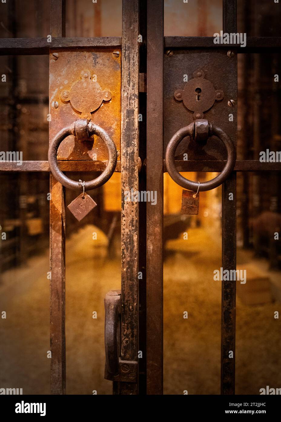 A vintage jail cell with a weathered metal door handle Stock Photo - Alamy