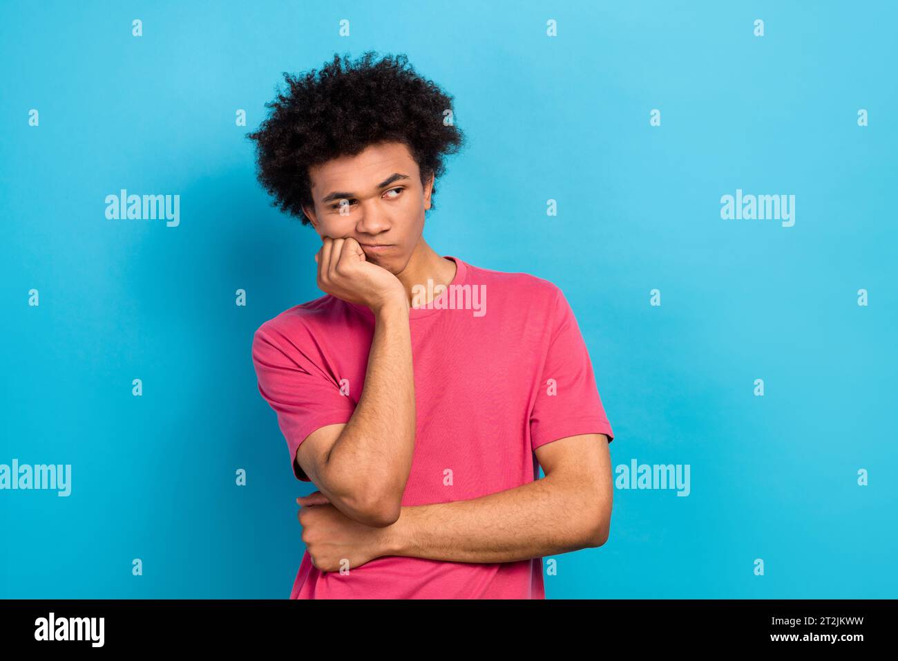Photo of disappointed funny guy with afro hairdo wear pink t-shirt hold ...