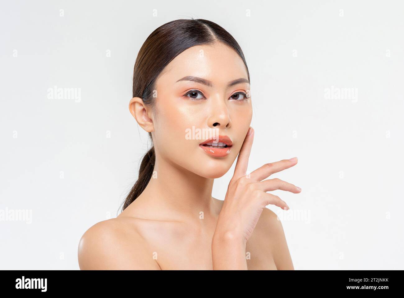 Beauty shot portrait of attractive Asian woman touching smooth skin on ...