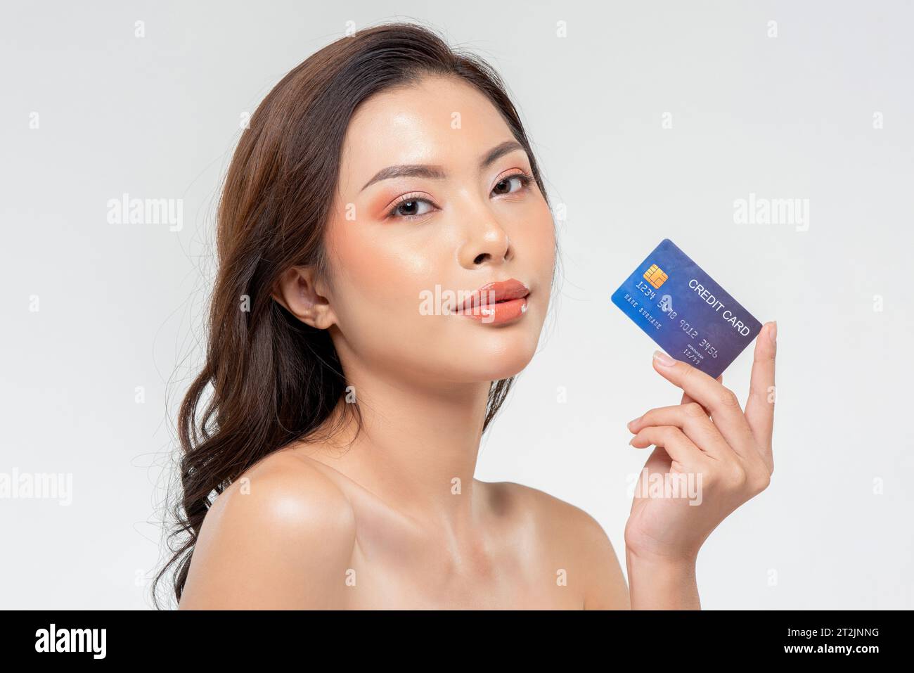 Beautiful Asian woman client with credit card in hand while standing on ...