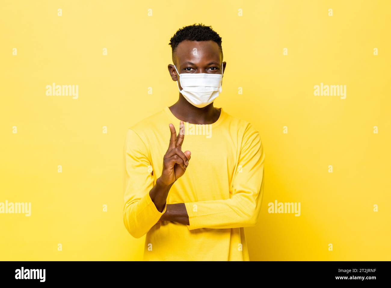 Young African man wearing face mask protecting from Covid19 and giving ...