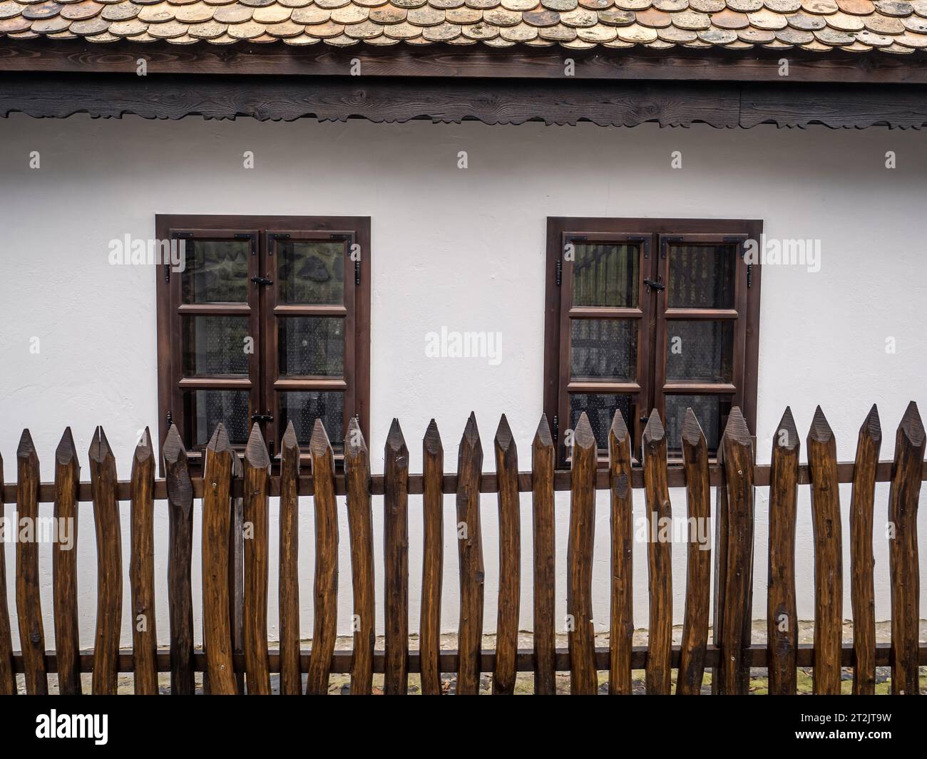 Frontal detail view of a traditional village house with white walls ...