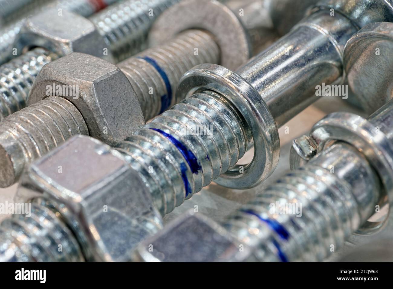 Group of galvanized screw-bolts with nuts and washers, abstract ...