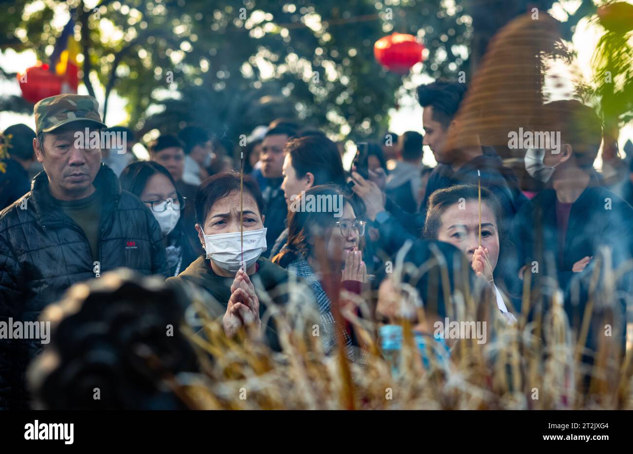 Vietnamese people light incense sticks and pray at Tran Quoc Pagoda in ...