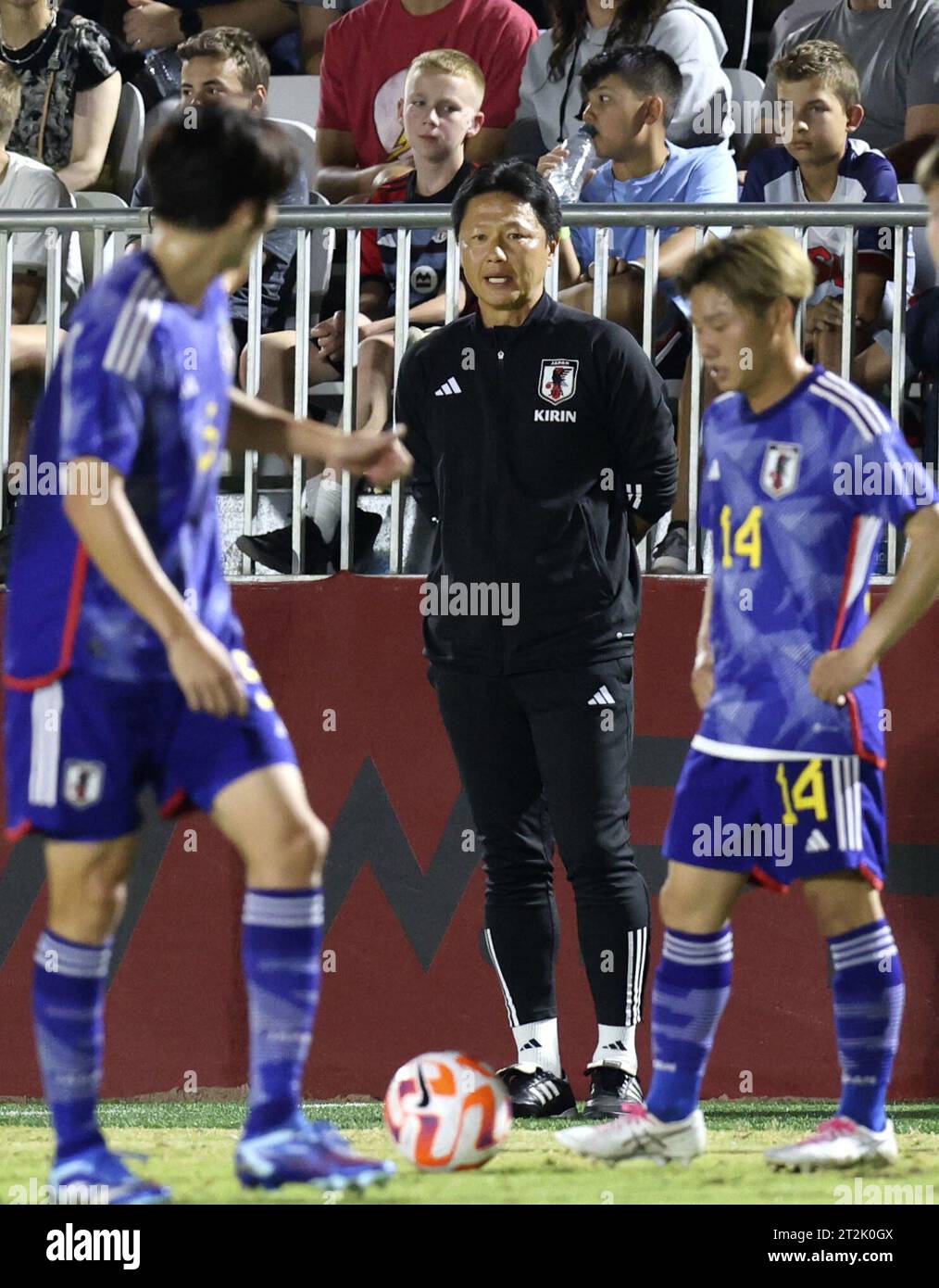Japan coach Go Oiwa (C) gives instructions during the second half of an ...
