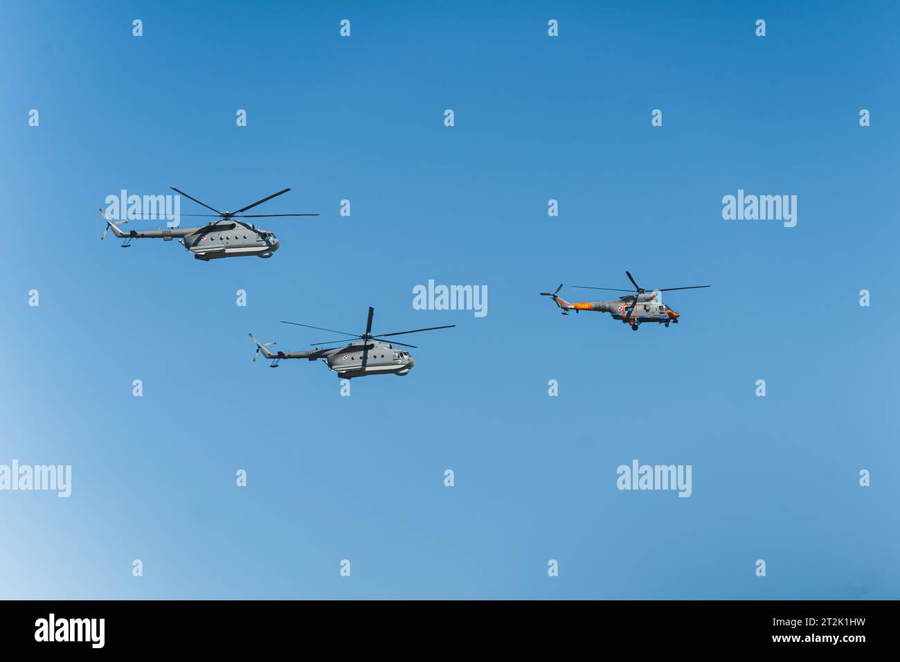 Three helicopters flying on a clear day at a military parade rehearsal ...
