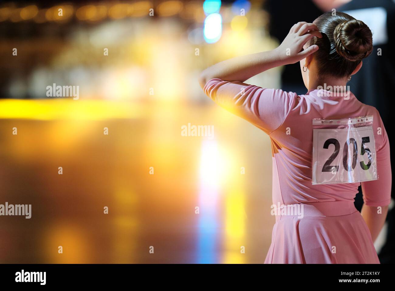 Behind the dancer - a girl dancer-athlete in a pale pink dress against ...