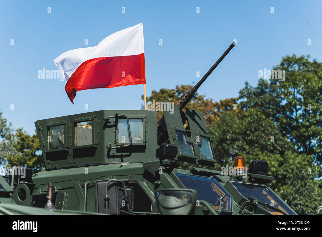 White and red flag floating on air on a military vehicles. Patriotism ...